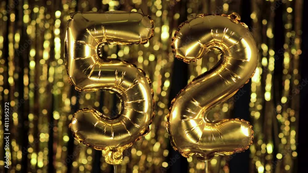 The golden number 52 fifty two is made from an inflatable ball on a ...