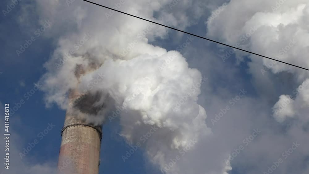 The chimneys of thermal power plants spew smoke into the air against ...