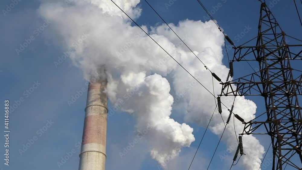 The chimneys of thermal power plants spew smoke into the air against ...