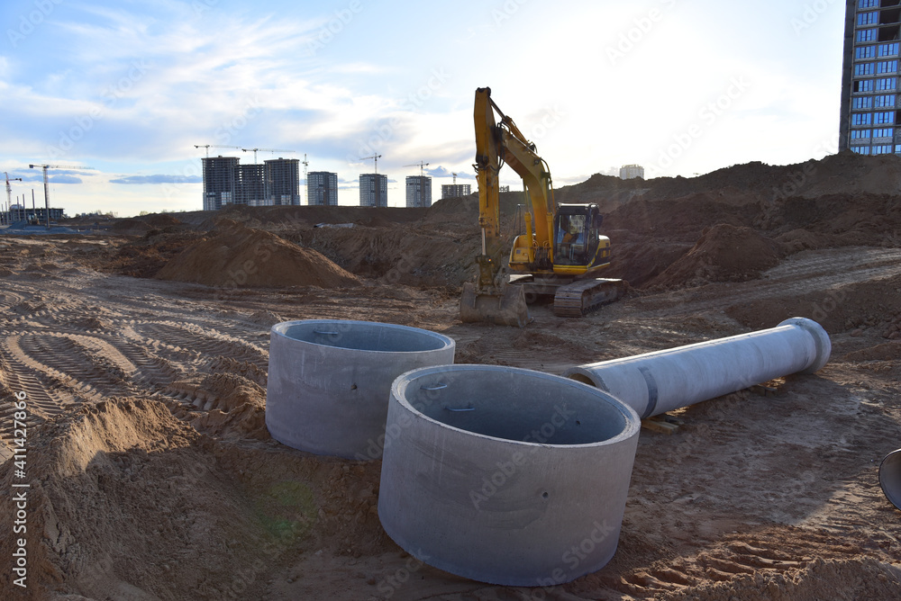 Excavator dig the trenches at a construction site. Laying concrete ...