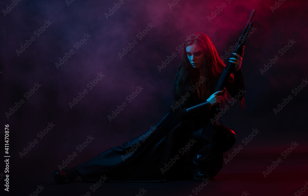 Vampire in black long corset dress in smoke holding a gun Stock Photo ...
