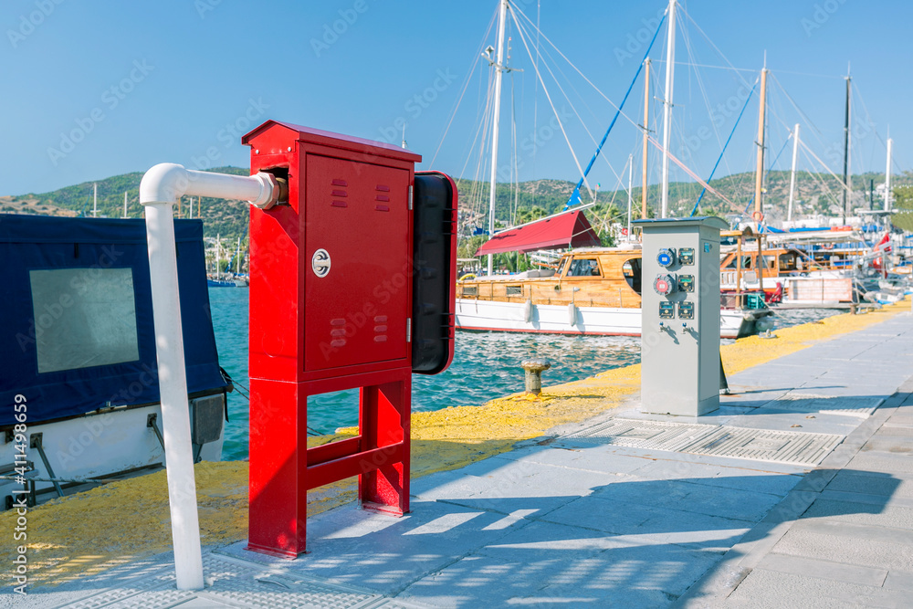 Red safety hydrant station at marina. Fire safety concept. Stock Photo ...