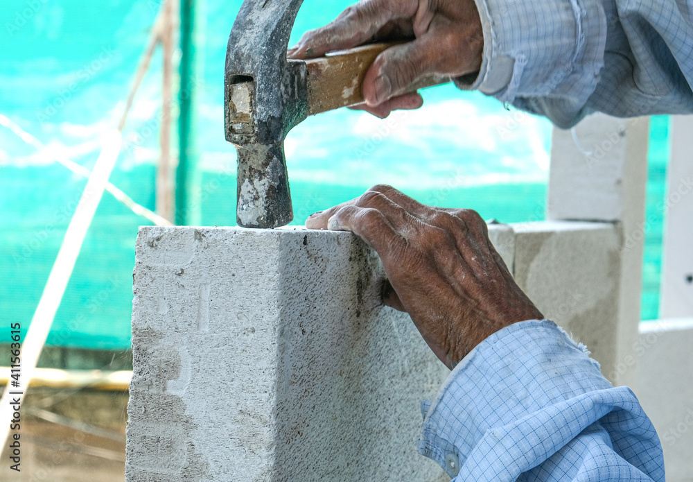 plaster worker use hammer hit nail iron extract white pillar structure ...