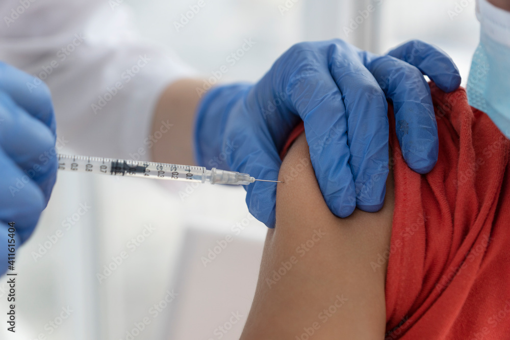 doctor's hands in medical gloves hold syringe with vaccine and making ...