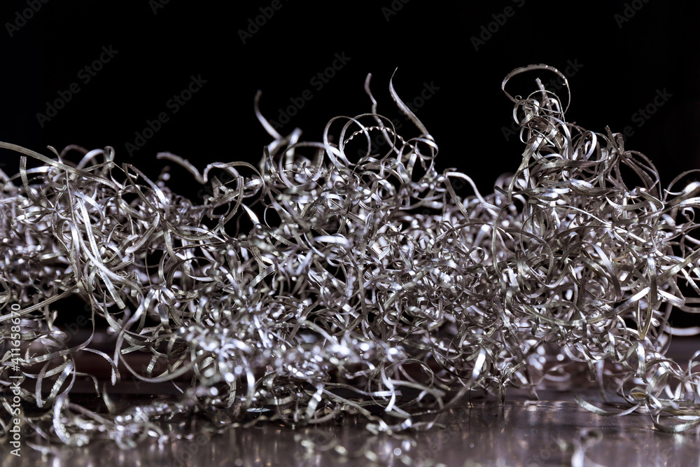 Shavings scrap metal. Curly metal shavings on a black background ...