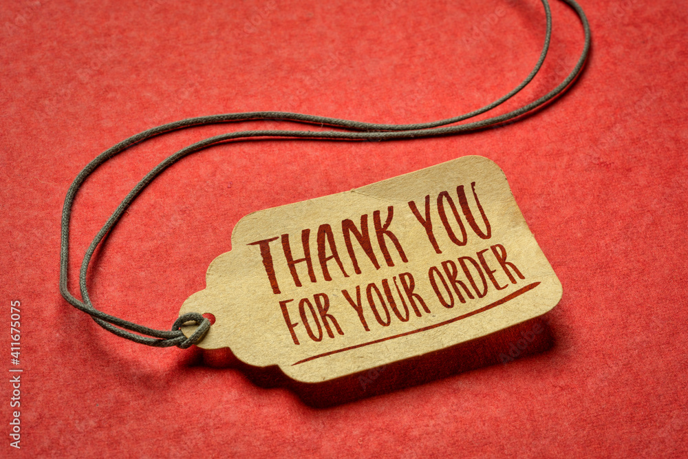 thank you for your order - sign a paper price tag against textured red ...