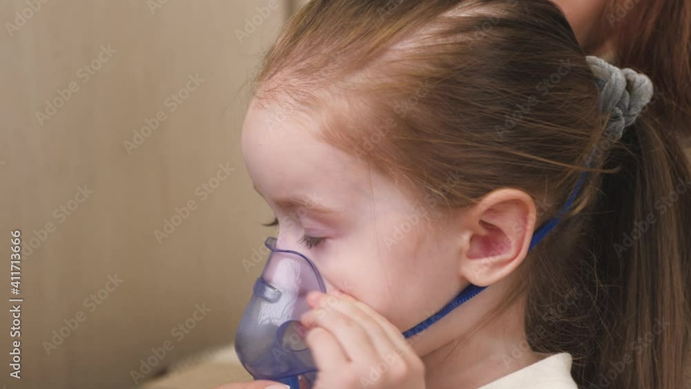 The child is receiving respiratory therapy with a nebulizer. Mommy ...