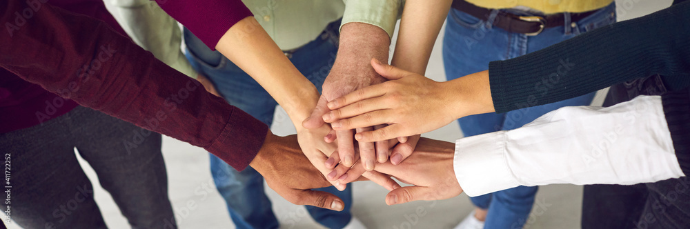 Top view of a group of people of different ages and nationalities fold ...