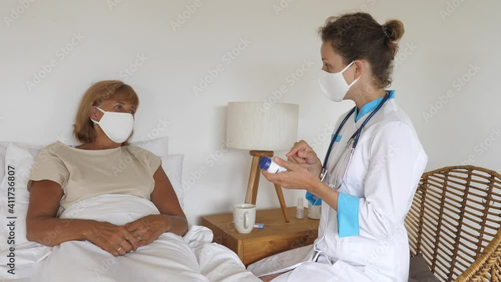 GP home visit. Female doctor gives prescription to older sick woman ...