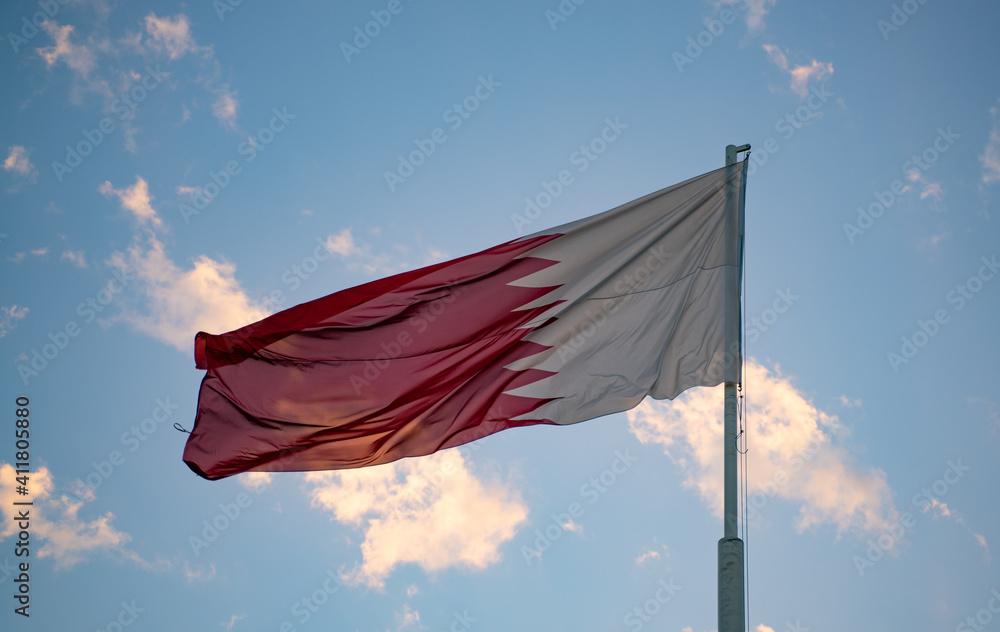 Qatar National flag flying high during the summer time in Al Bidda Park ...