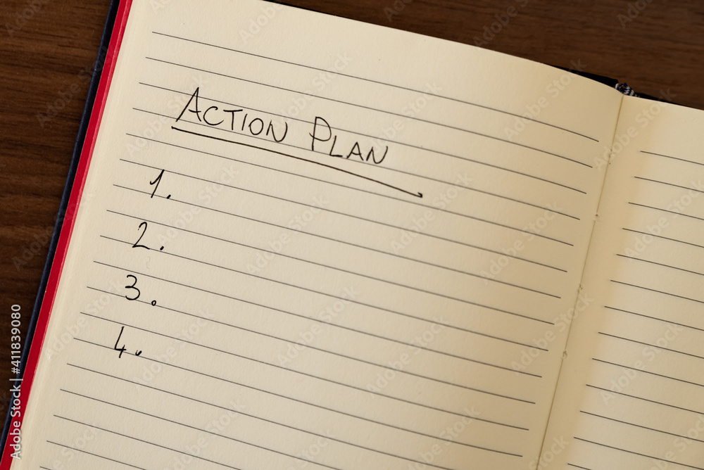 Lined notebook page with the words 'Action plan' in black ink on white ...