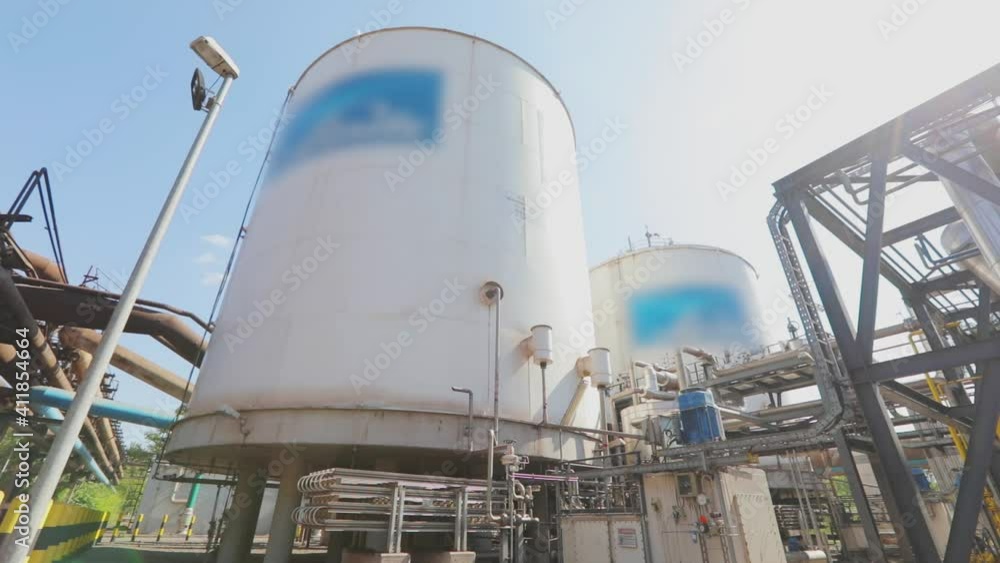 White storage tanks for liquids in a modern factory. Large storage ...