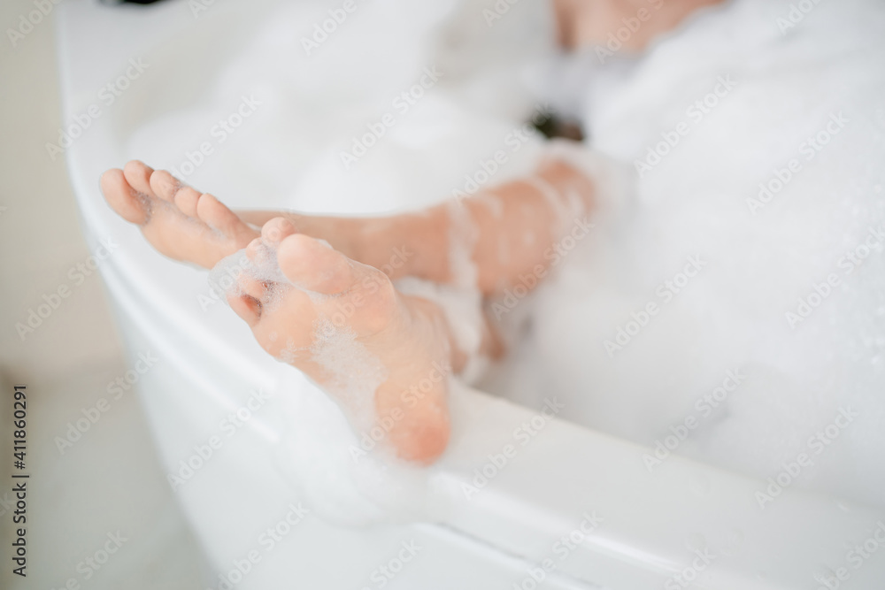 Women's feet she is taking a bath in the bath with relaxation. Stock ...