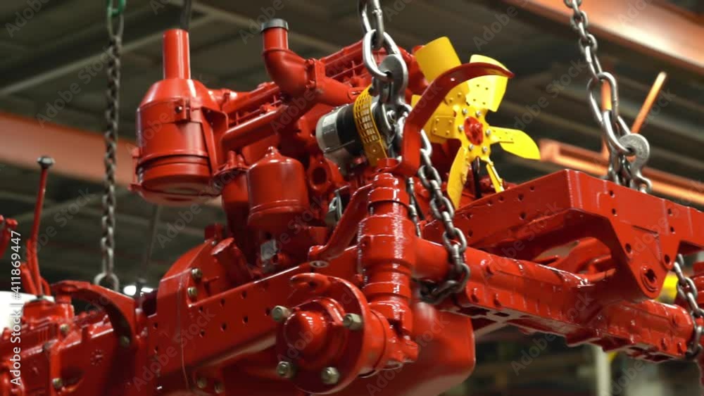 Moving the tractor engine around the shop on the crane beam, the engine ...
