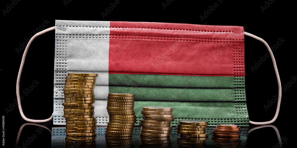 Medical mask with the flag of Madagascar behind some shrinking stacks ...