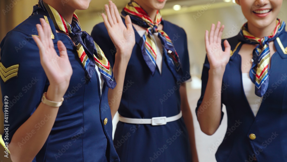 Cabin crew waving hand for greeting or goodbye . Airline transportation ...