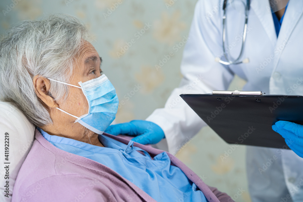 Asian doctor wearing face shield and PPE suit new normal to check ...
