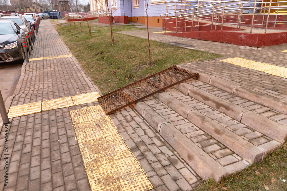 Elements of a barrier-free environment. Metal ramp and tactile tiles on ...