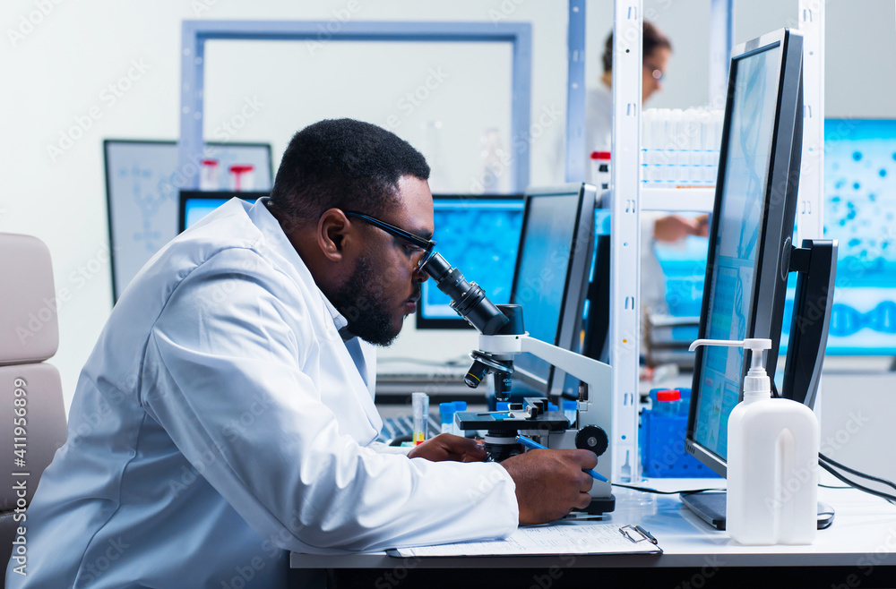 Professional African-American scientist is working on a vaccine in a ...
