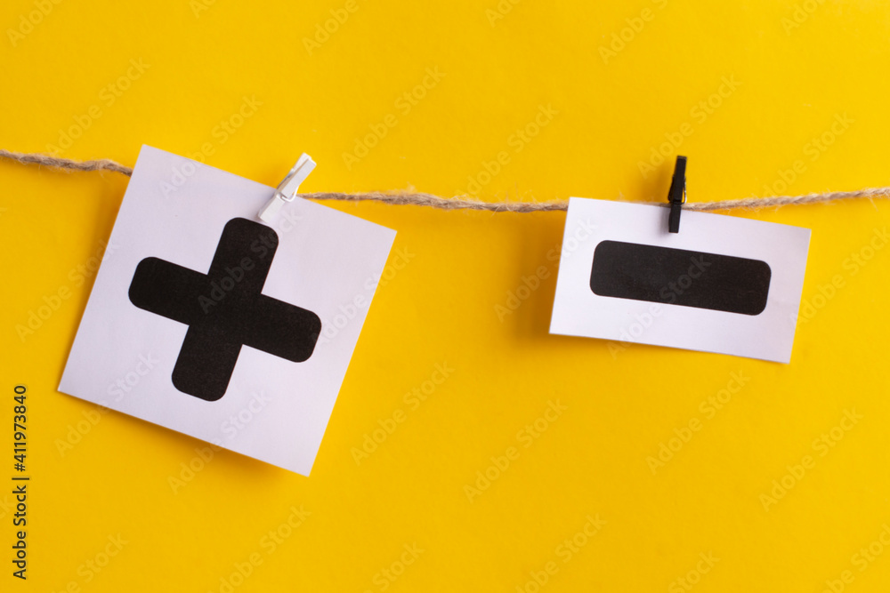 Symbols of black color plus and minus on yellow background. Abstraction ...