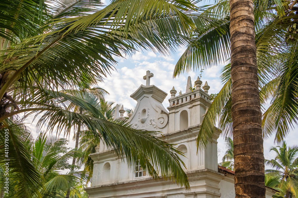 Portuguese christian church among coconut palm trees in Goa, India ...