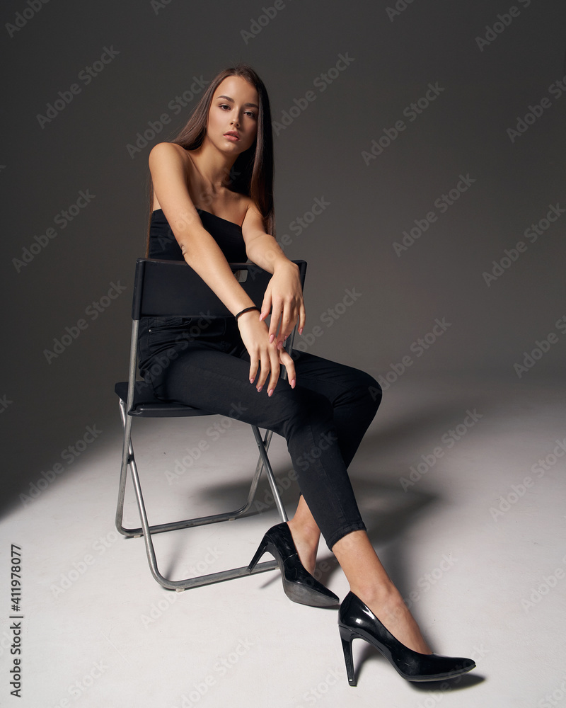 Full length studio portrait of young slim tanned caucasian girl in ...