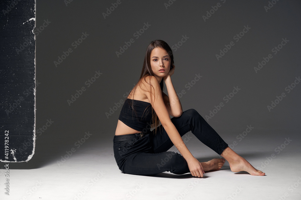 Full length studio portrait of young slim tanned caucasian girl in ...