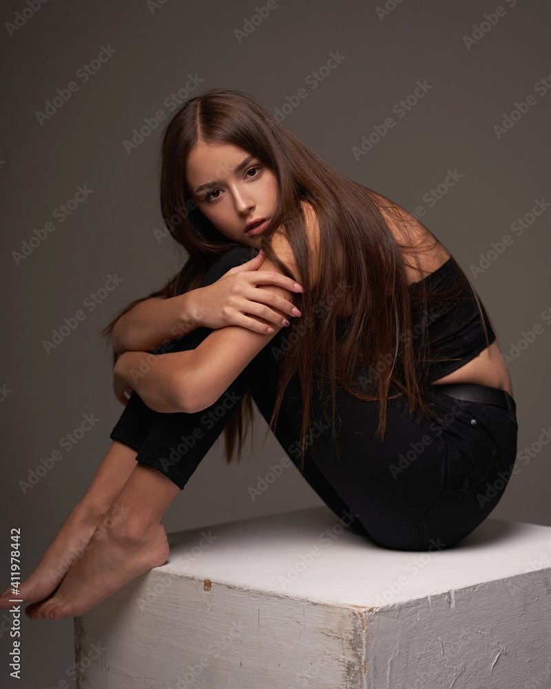 Full length studio portrait of young slim tanned caucasian girl in ...