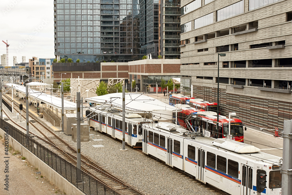 Lightrail and city buses in line near Union Station and the Millennium ...