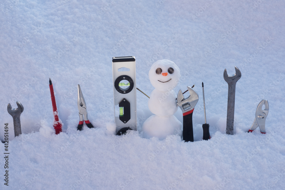 Repairing tools. Snowman with repairing instrument. Snow man worker ...