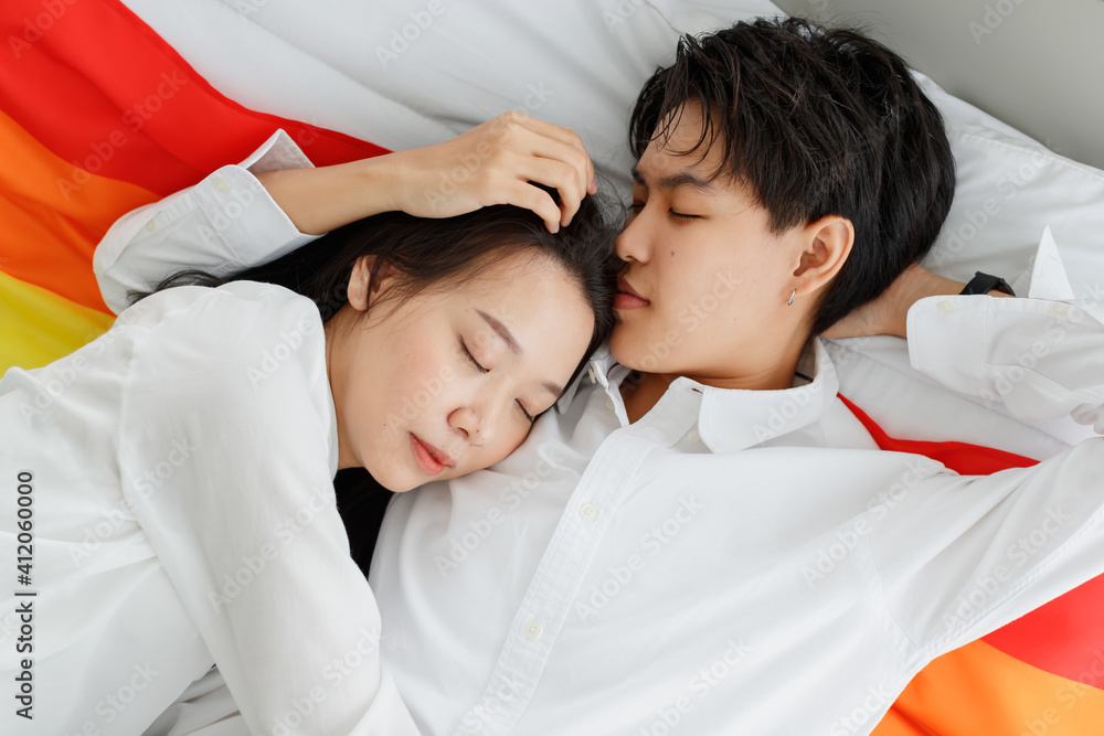 LGBTQ couple lovers, a handsome girl as man or butch hold and cuddle ...