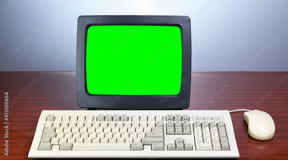 An old retro CRT monitor with a green screen for adding video and ...