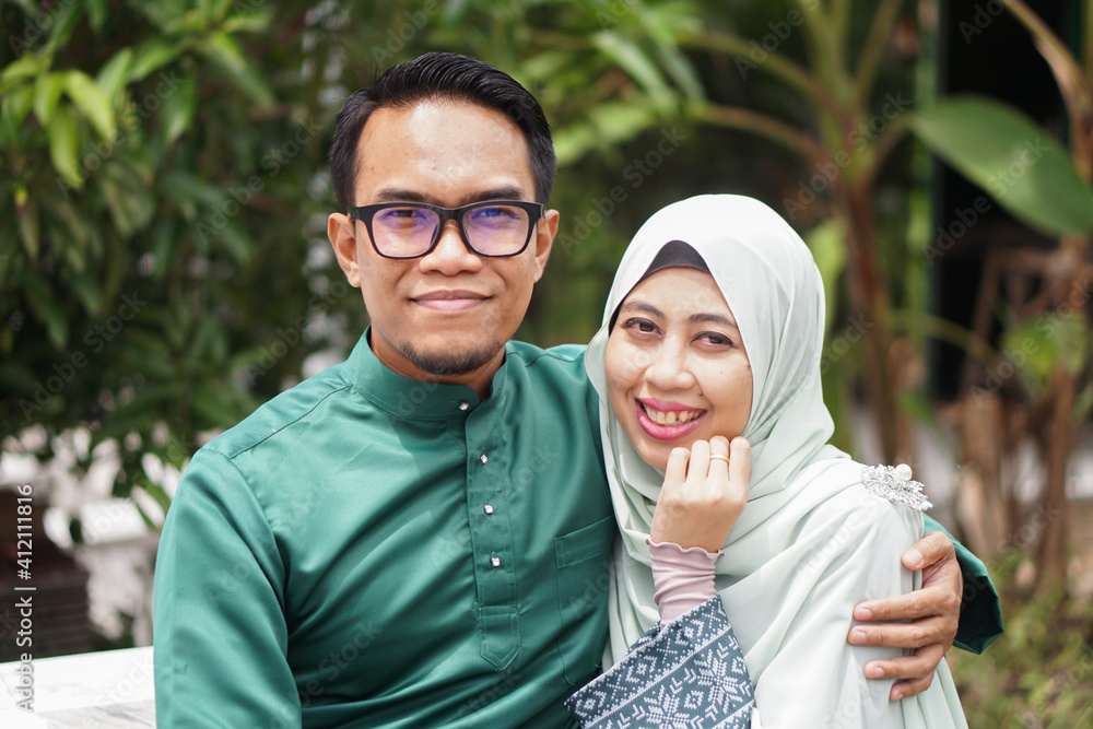 Portrait of a Muslim Malay couple wearing Malay traditional attire with ...
