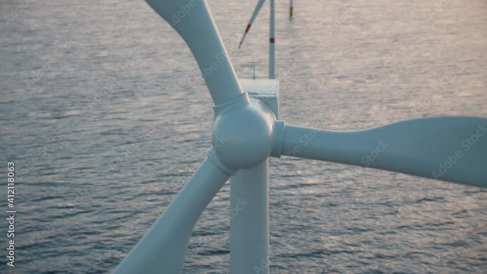 Camera moves around the head of a wind turbine to reveal an aerial view ...