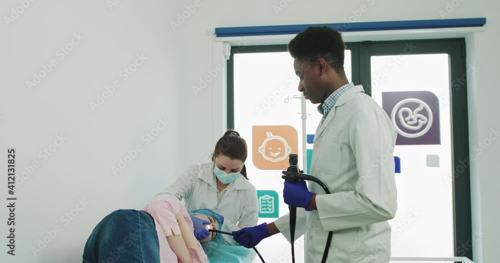 Medical Team Examining Colon Of Patient Who Lying On Bed ...