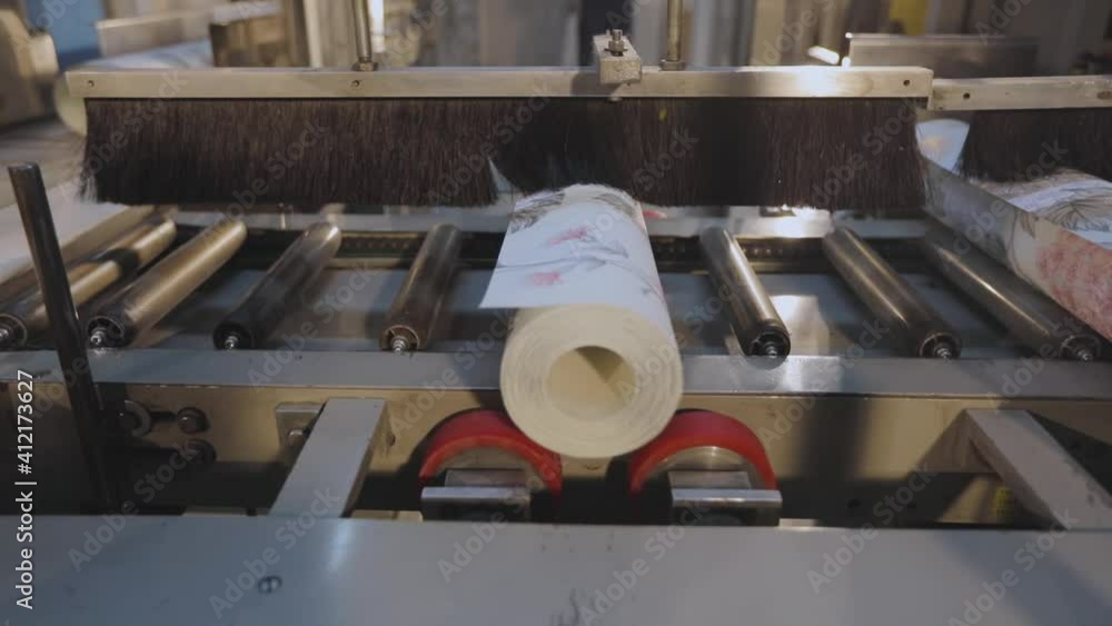 A roll of wallpaper on a conveyor line. Roll of wallpaper. Conveyor ...