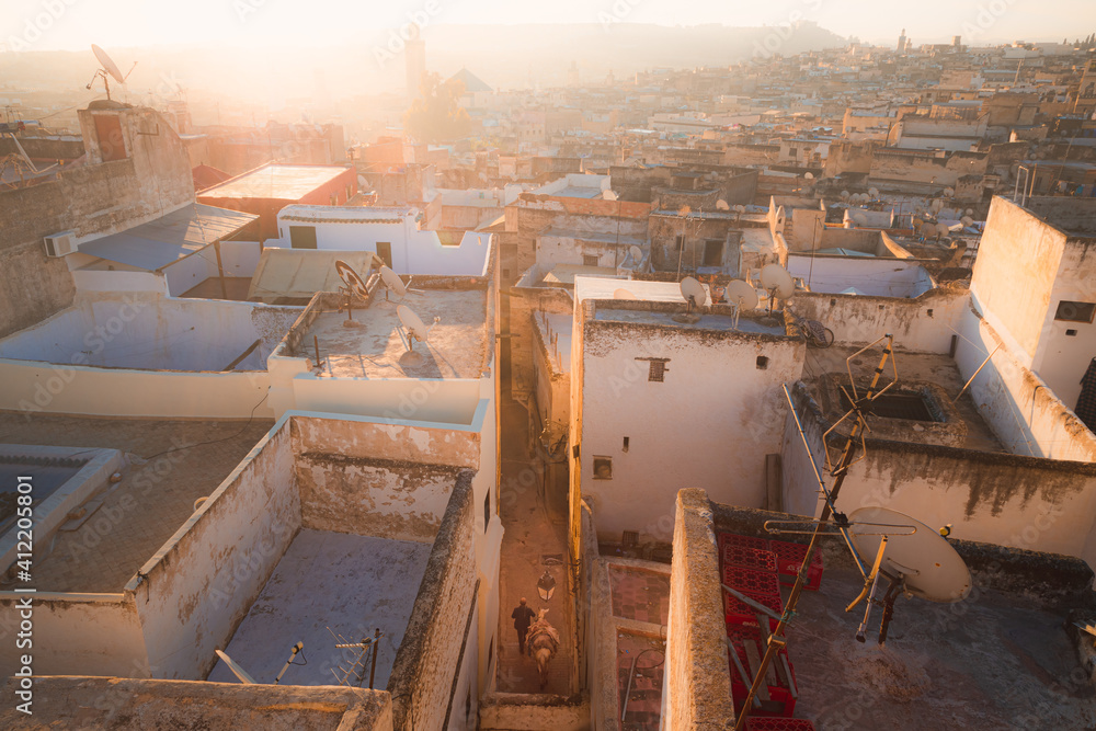 Sunrise or sunset cityscape rooftop view over the old town of Fez ...