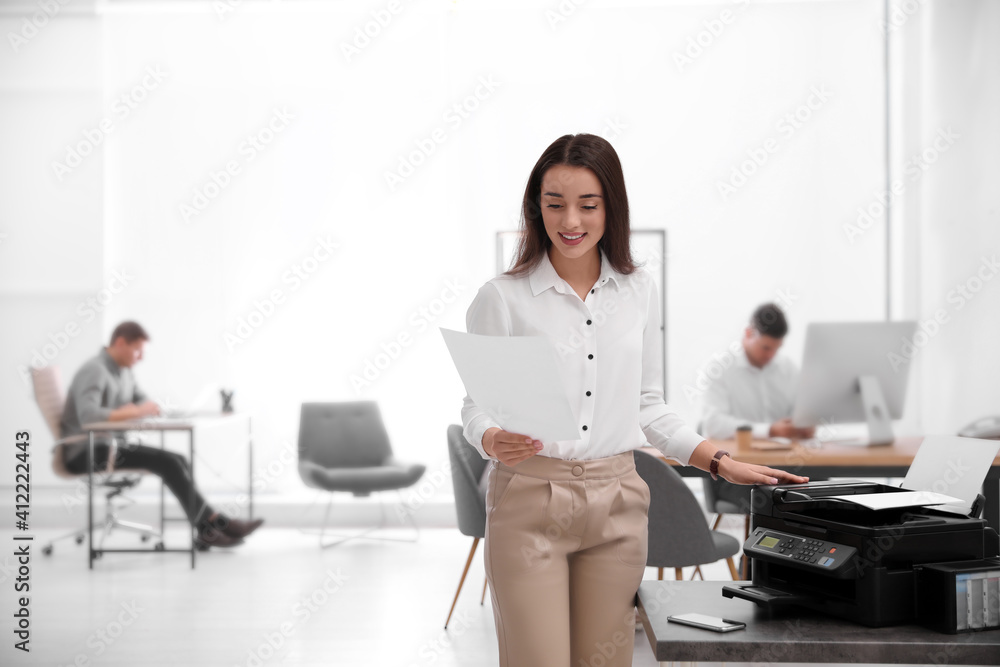 Employee using new modern printer in office Stock Photo | Adobe Stock