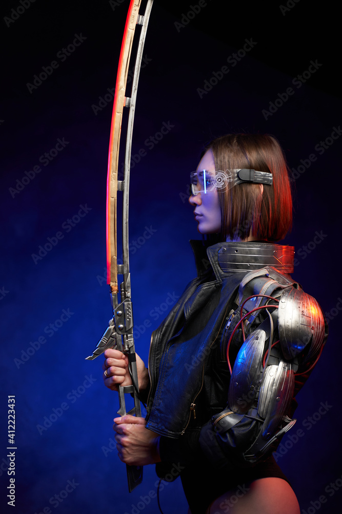 Seductive female assassin poses in dark background looking at her ...