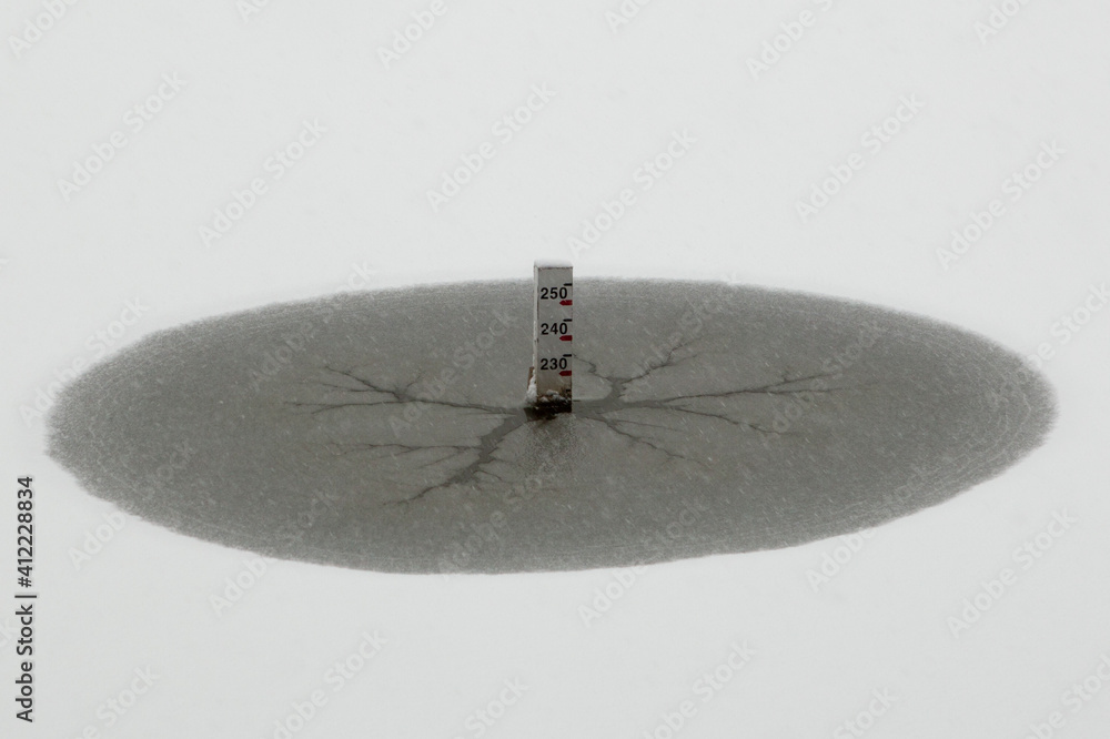 Snow and depth indicator on a frozen lake Stock Photo | Adobe Stock