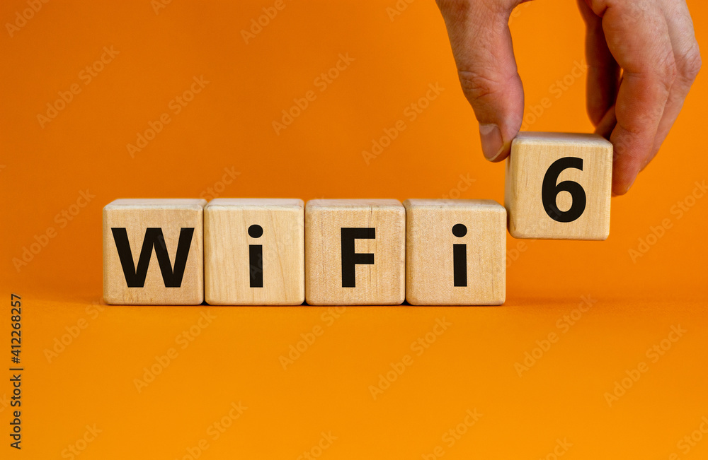 WiFi 6 symbol. Businessman holds a wooden cube with words WiFi 6 ...