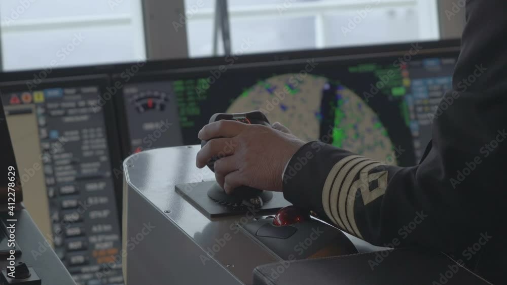 Captain steers the ship by azimuth controller. Hand turns the joystick ...