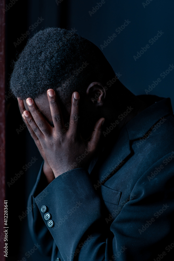 Stress african man in dark room , Low key style Stock Photo | Adobe Stock