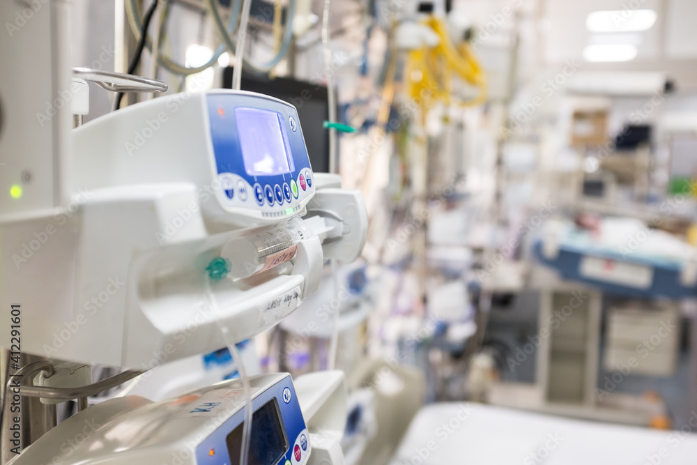Medical device in UK NHS EMS ICU hospital room,infusion pump dripping ...