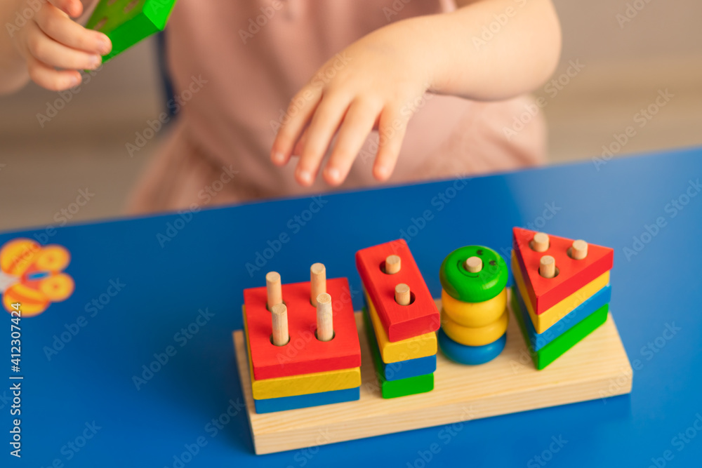 Children's wooden toy. The child collects the sorter. Educational logic ...