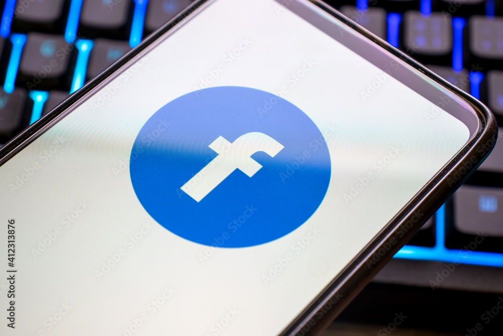 Foto de Mobile phone with blue facebook logo on display and colorful ...