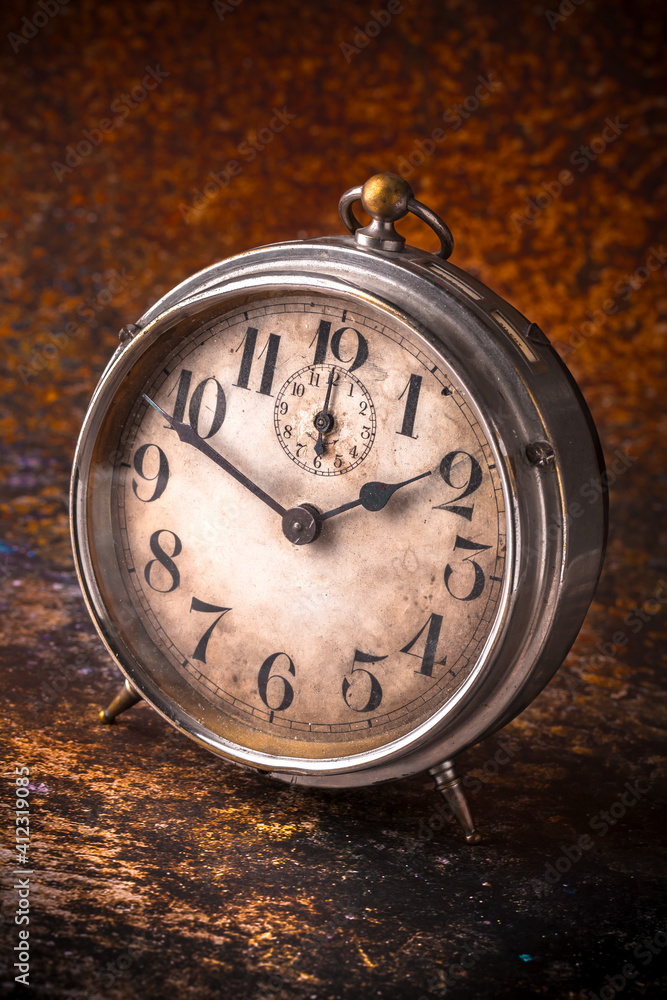 Old rustic clock close up arrangement on vibrant color background front ...