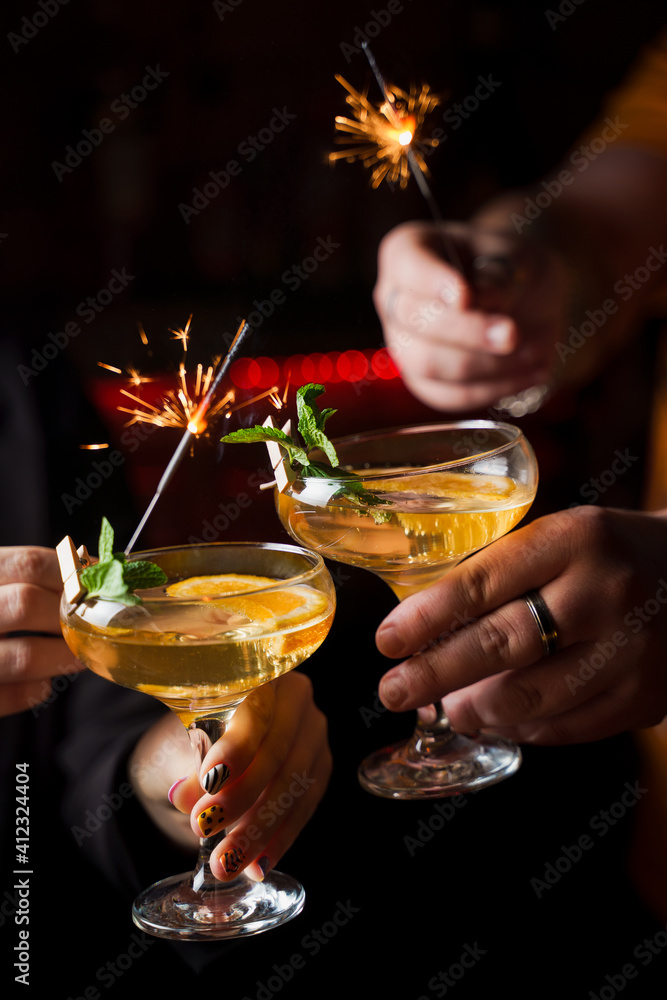 Celebrating new year eve 2022 with sparklers fireworks and drinking ...