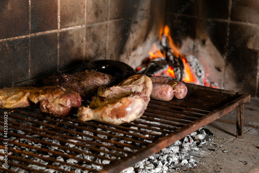 Barbecue. Meat cuts of cow, chicken and pork warming on the embers on ...