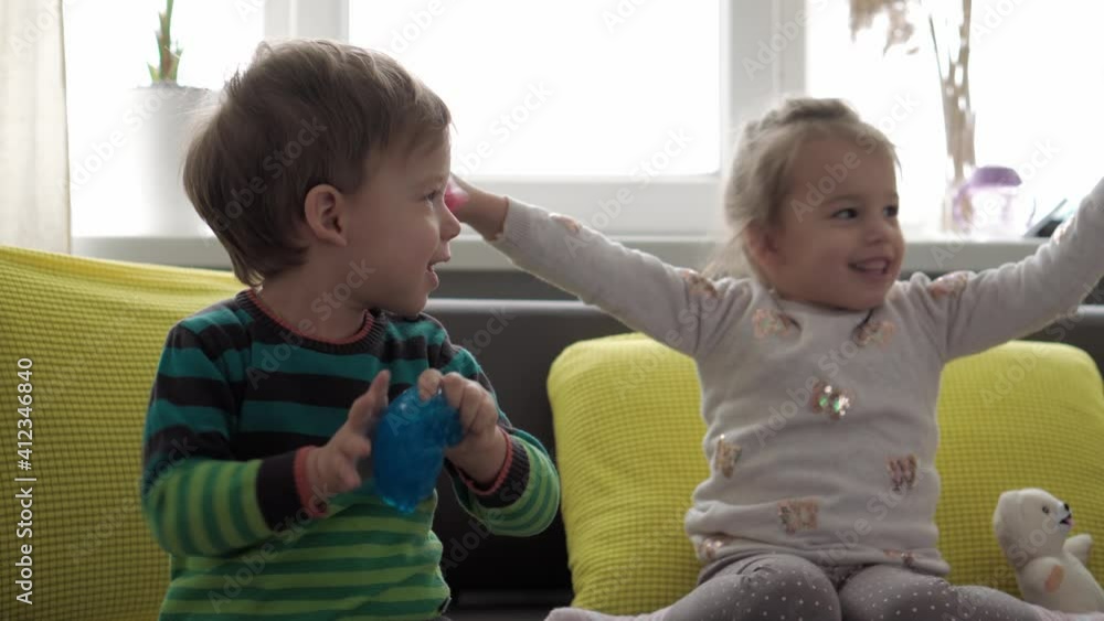 authentic baby hands with blue and red slime. Girl and boy preschool ...